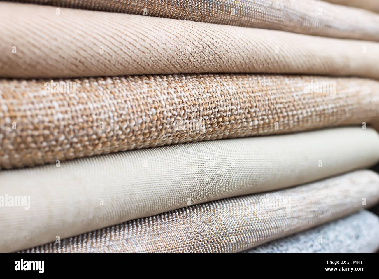 Pile of folded colorful textile. Heap of cloth fabric Stock Photo - Alamy