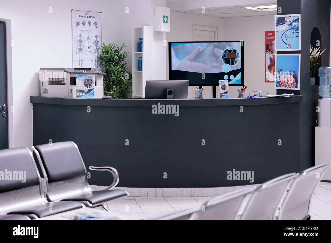 Hospital reception with waiting room in facility lobby, registration counter used for patients ...