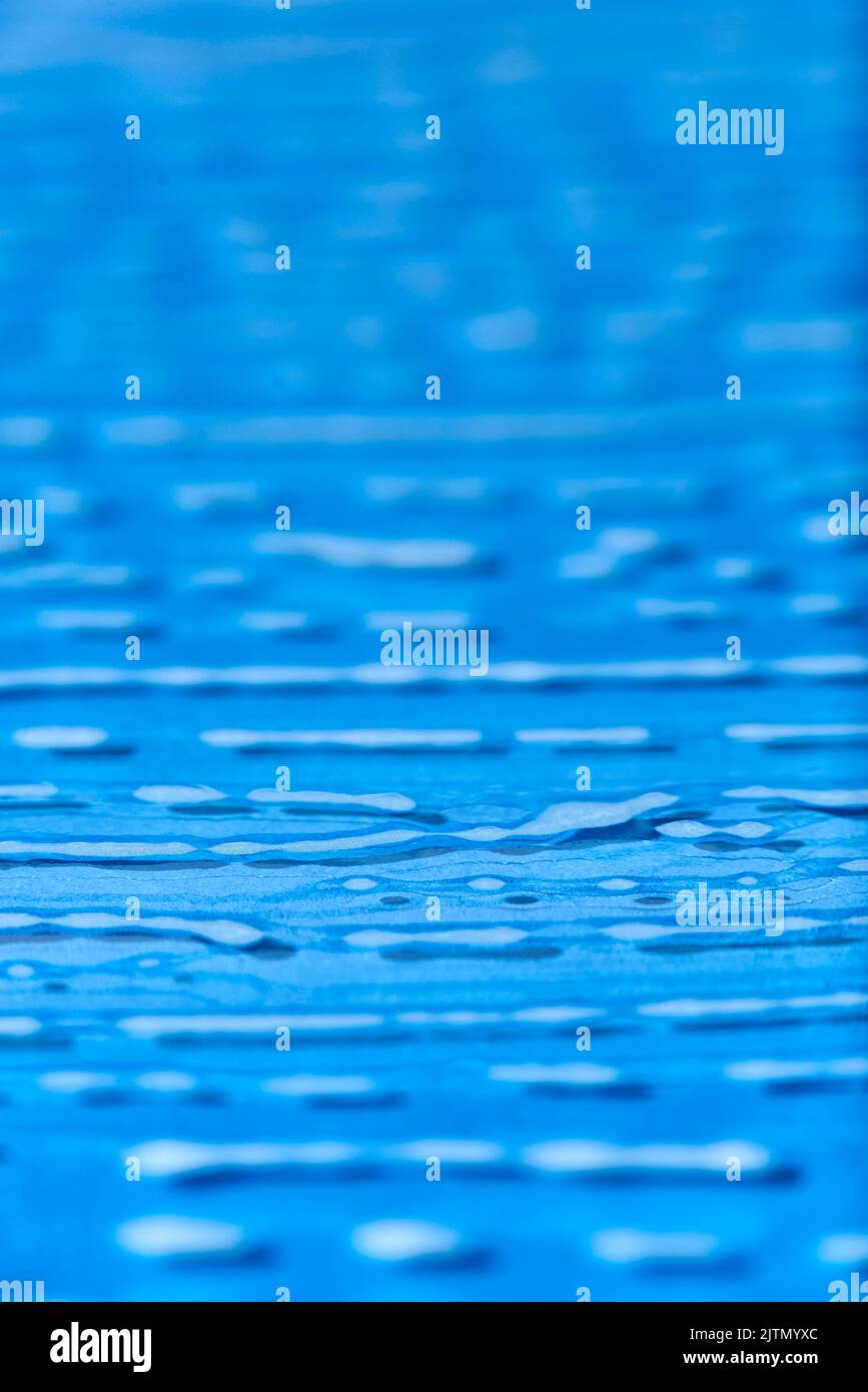 Blue glass surface covered with soap foam. Monochromatic abstract ...