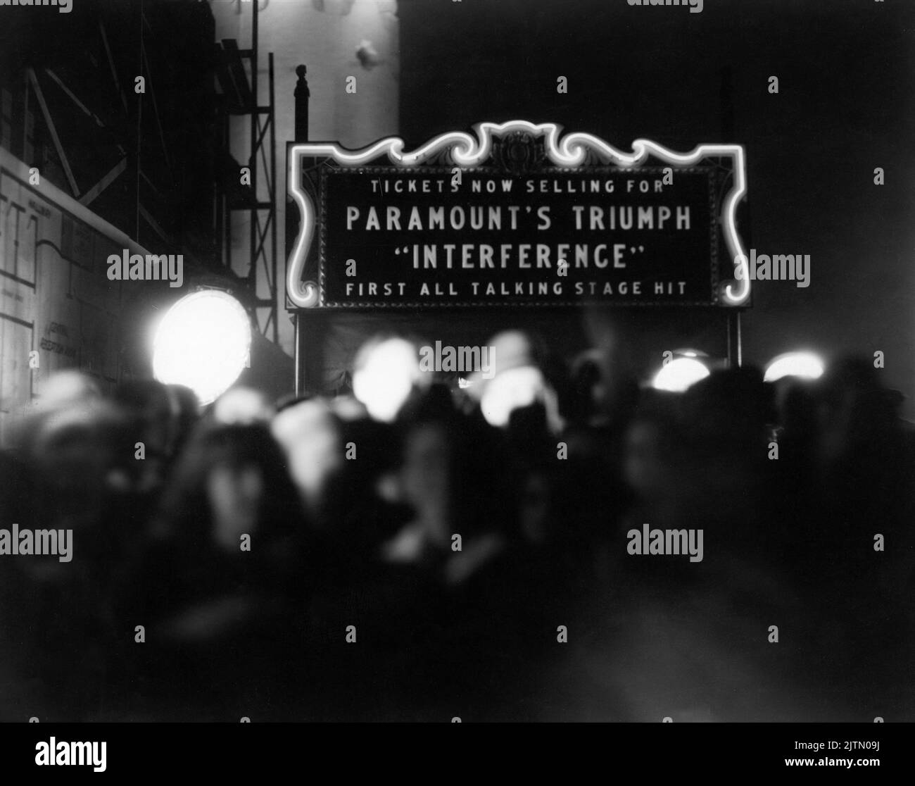 Crowd at night outside unidentified US Movie Theatre with advertisement ...