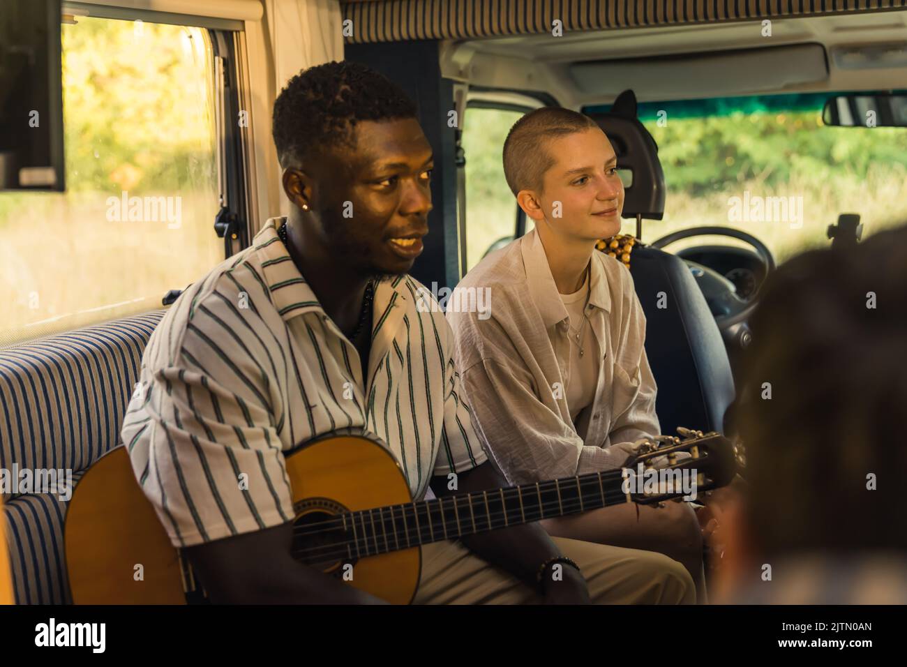 Multi-ethnic group of close friends on a summer road trip in a camping ...
