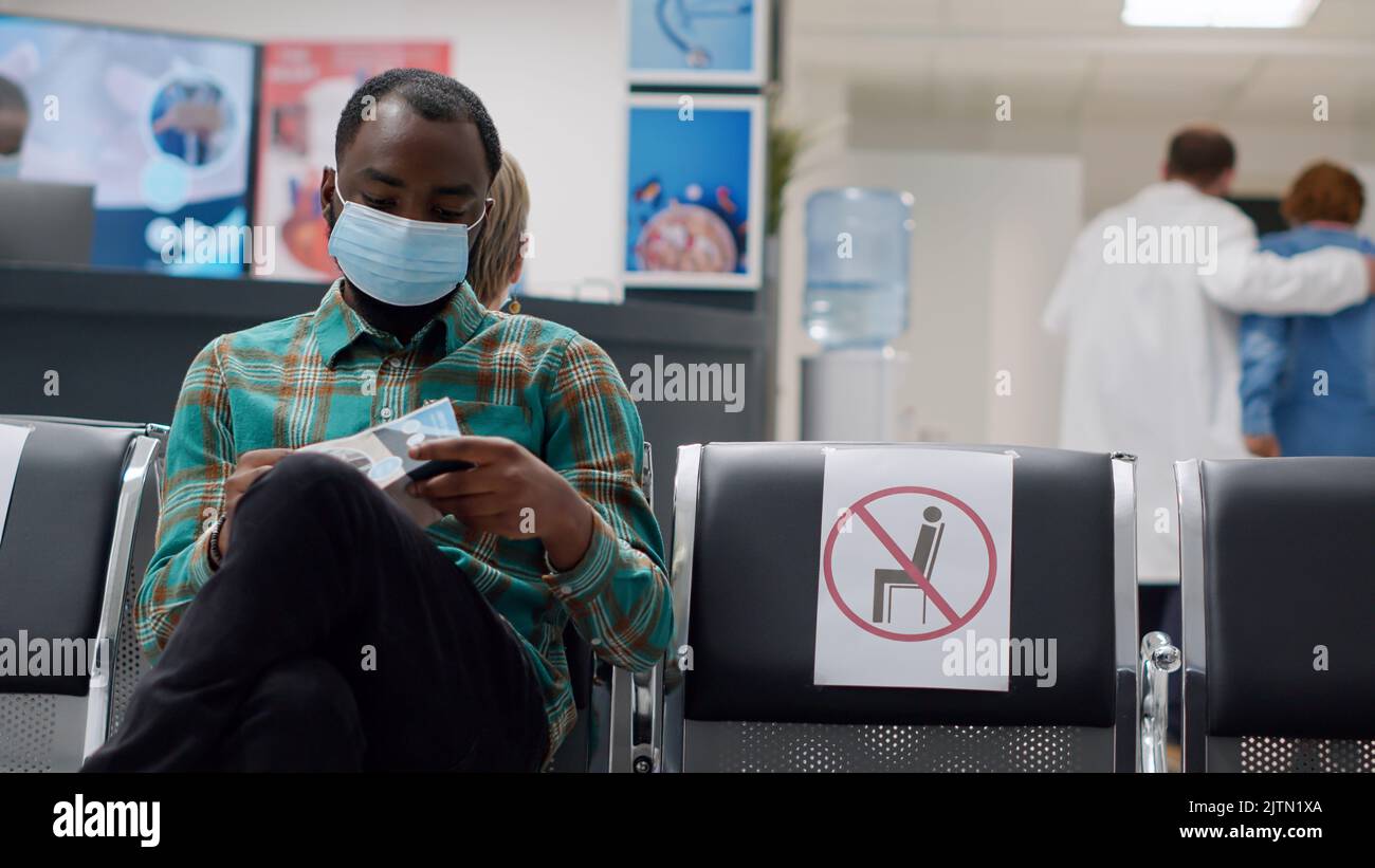 Diverse patients sitting in waiting room lobby to attend checkup visit ...