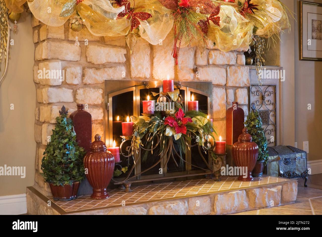 Fireplace mantle with illuminated Christmas decorations Stock Photo - Alamy