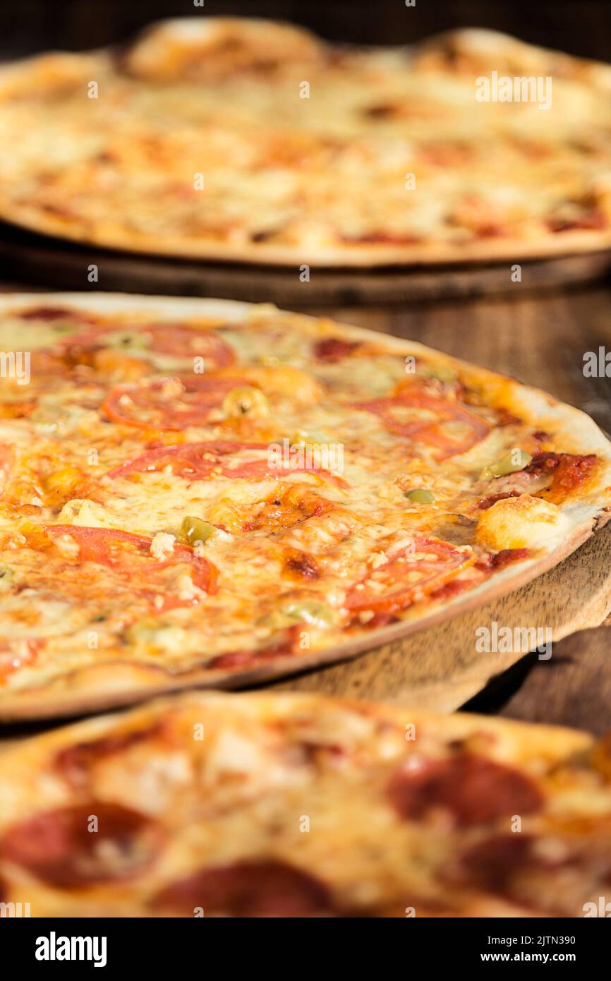 Three pizzas of different flavors. Pepperoni, cheese, potato, onion ...