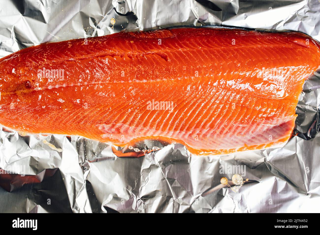 orange Pacific salmon filet on foil ready to grill Stock Photo - Alamy