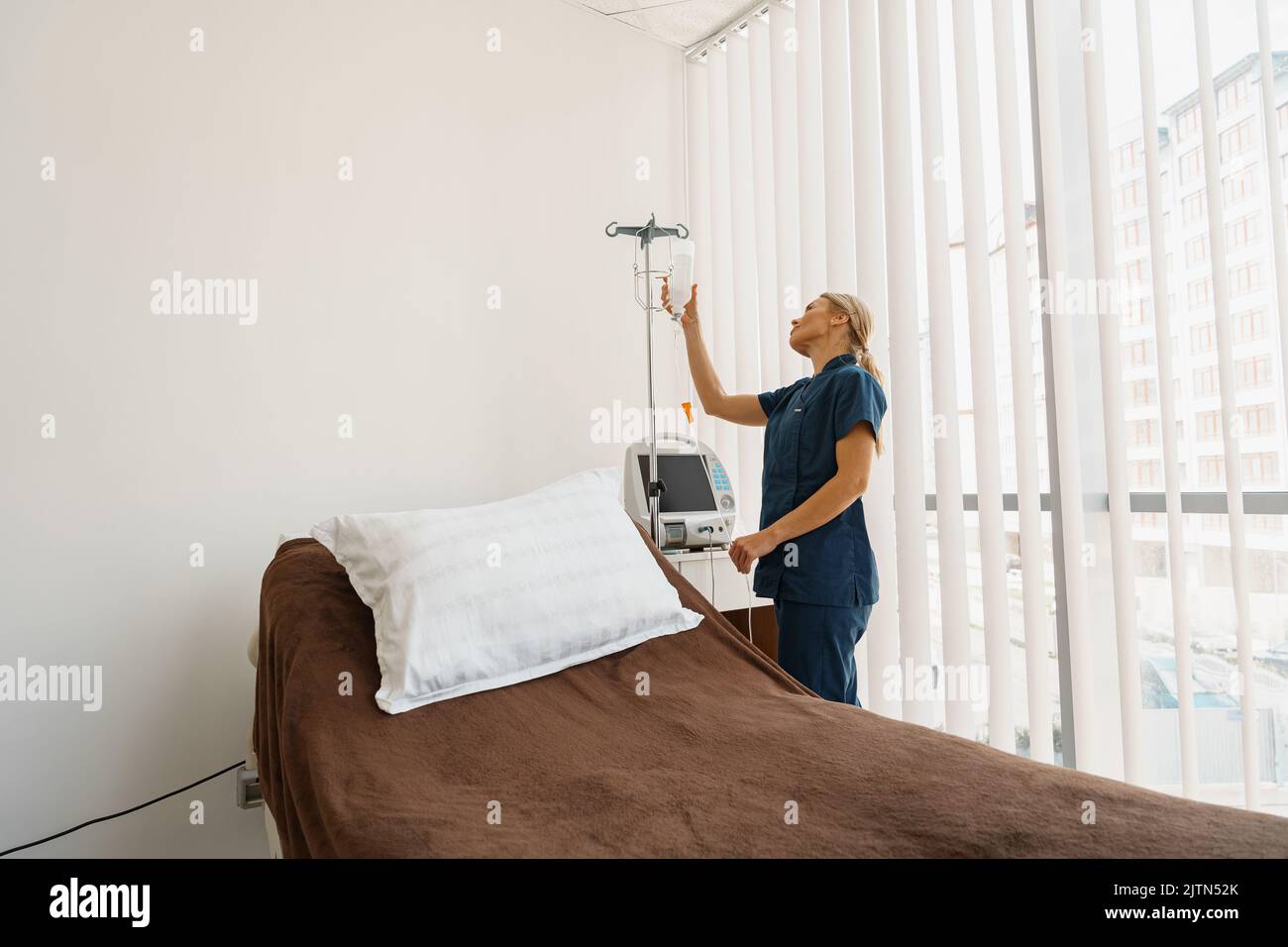 Professional nurse preparing an intravenous drip before procedure in ...