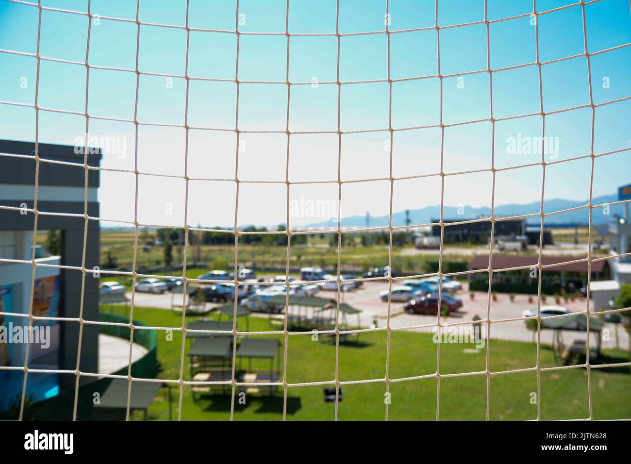 The city behind the mesh , the net, the macro City view between rusty ...