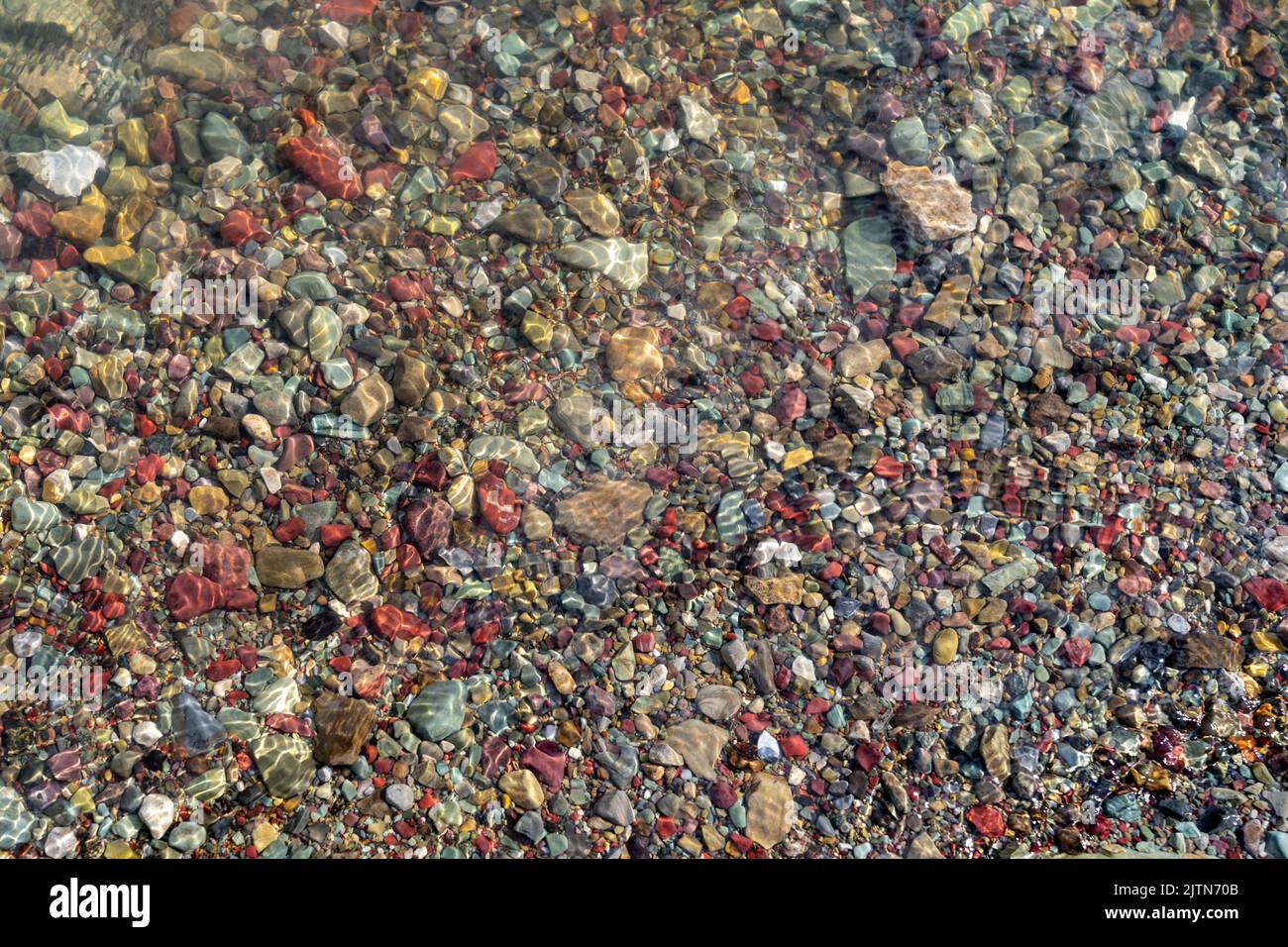 Colorful rocks and pebbles underwater at Glacier National Park Montana ...