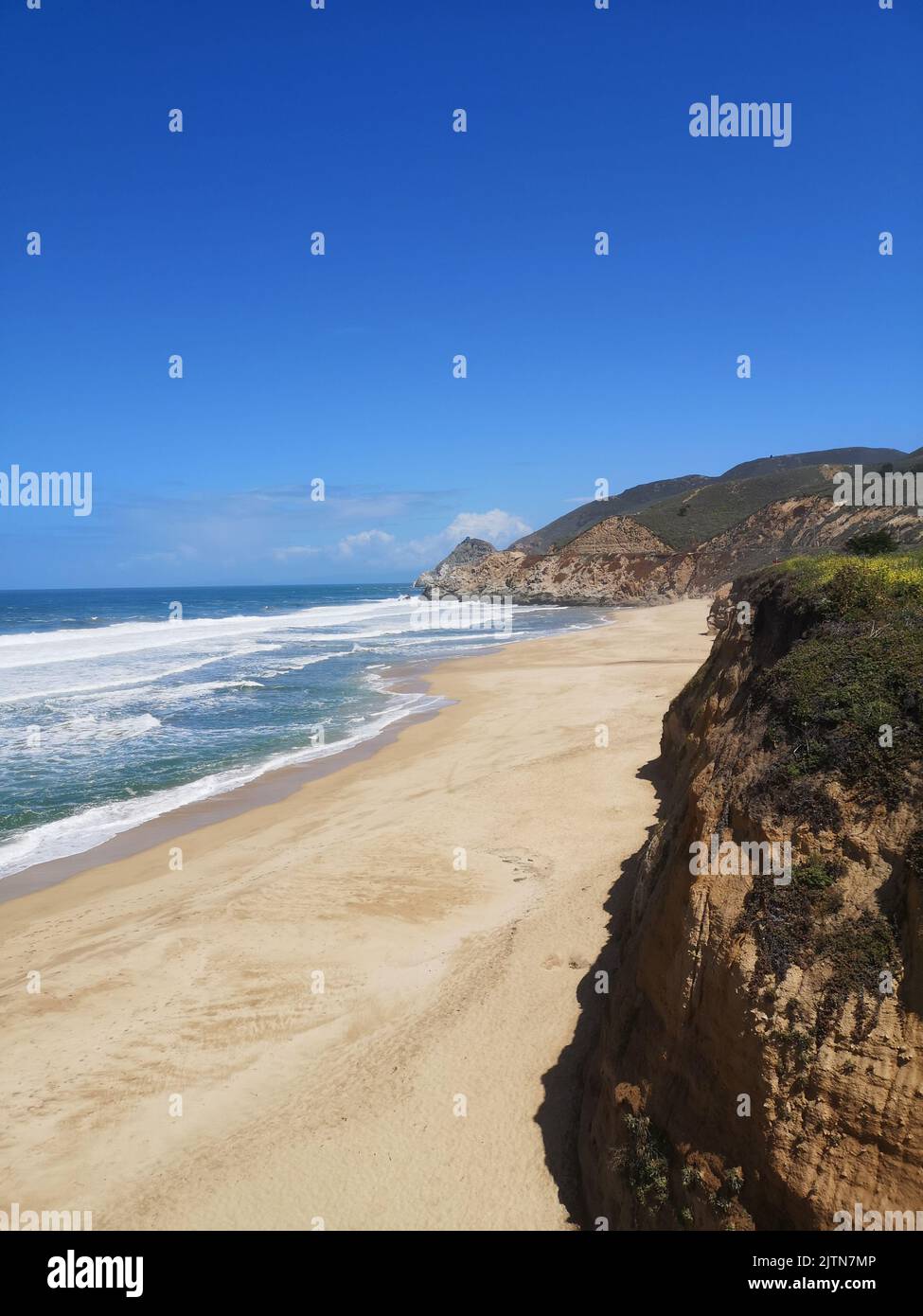 A beautiful long beach and island in California, USA under a clear blue ...