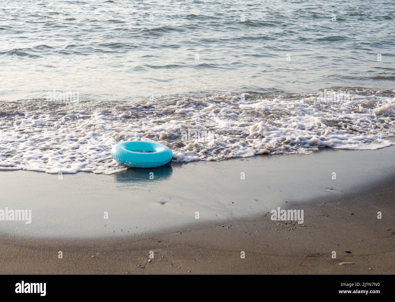 The swimming ring is carried by the wave. Inflatable circle on the ...
