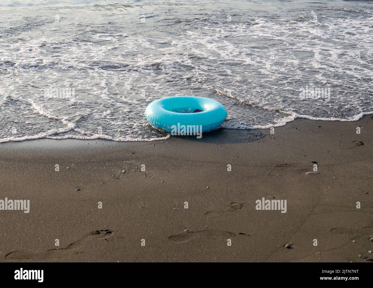 The swimming ring is carried by the wave. Inflatable circle on the ...