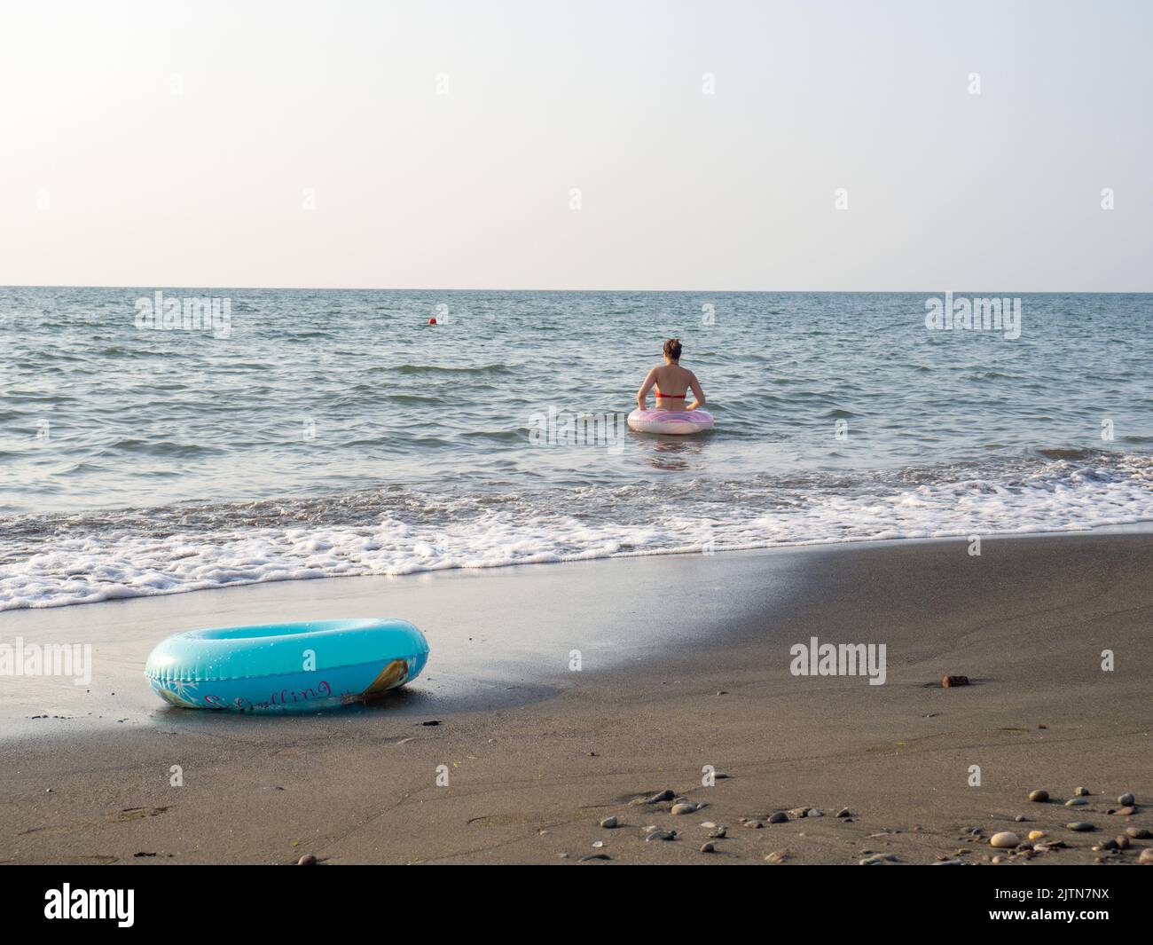 The swimming ring is carried by the wave. Inflatable circle on the ...