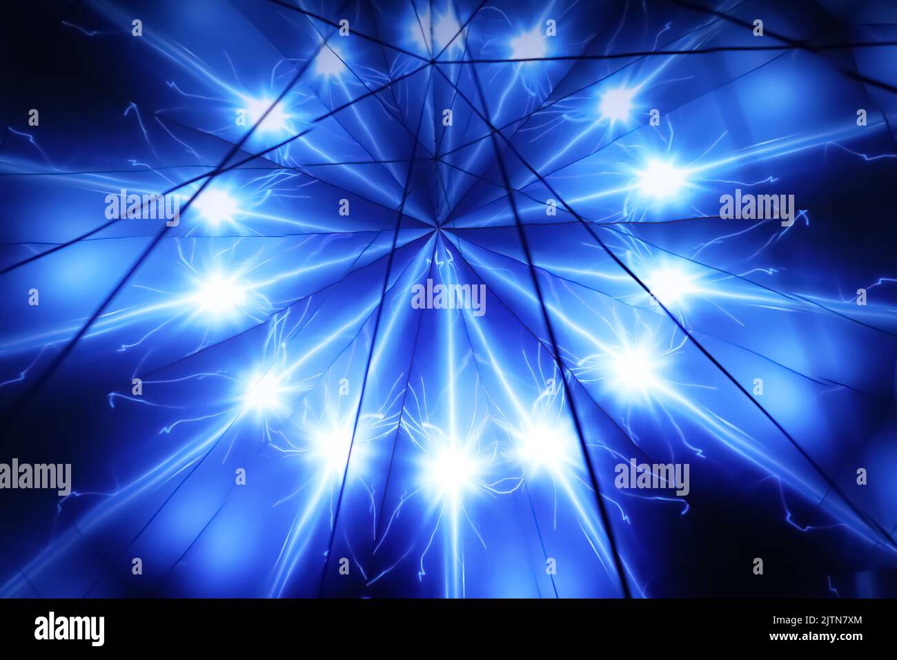 Neon kaleidoscope star beams sparkle in the dark. Background picture ...