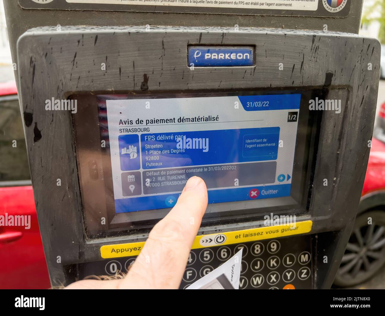 Strasbourg, France - Mar 31, 2022: POV male hand looking at Parkeon ...