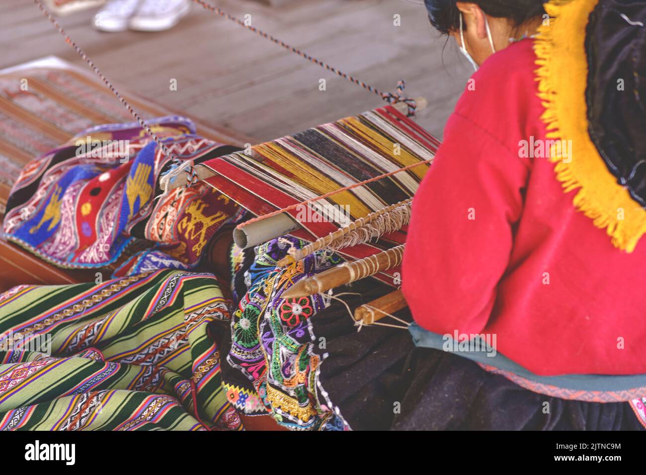Indigenous woman showing traditional weaving technique and textile ...