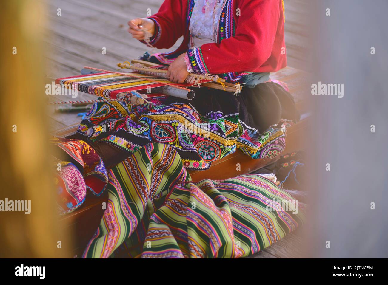 Indigenous woman showing traditional weaving technique and textile ...