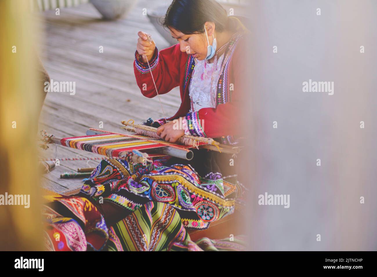 Indigenous woman showing traditional weaving technique and textile ...