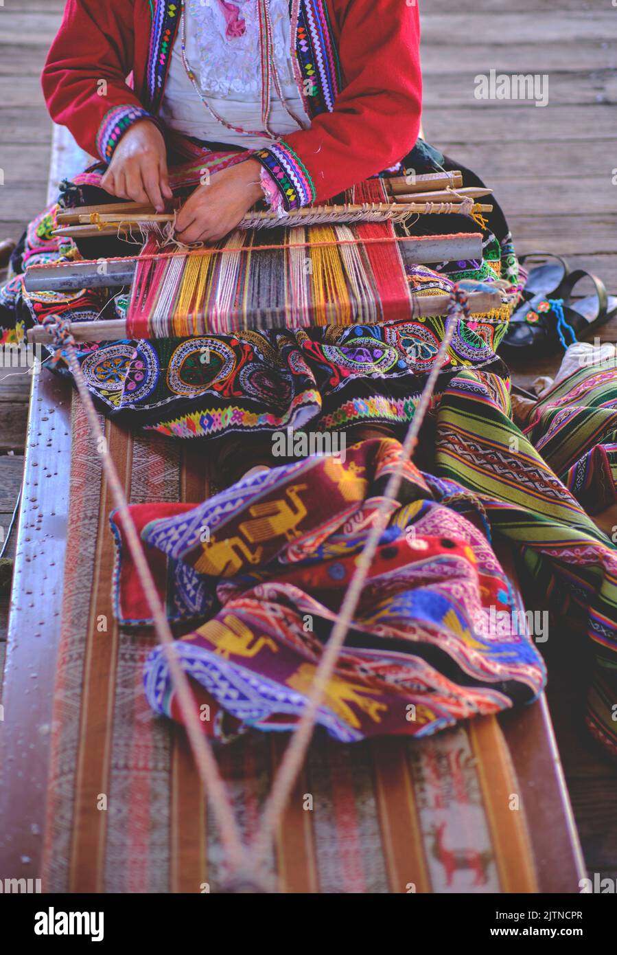 Indigenous woman showing traditional weaving technique and textile ...