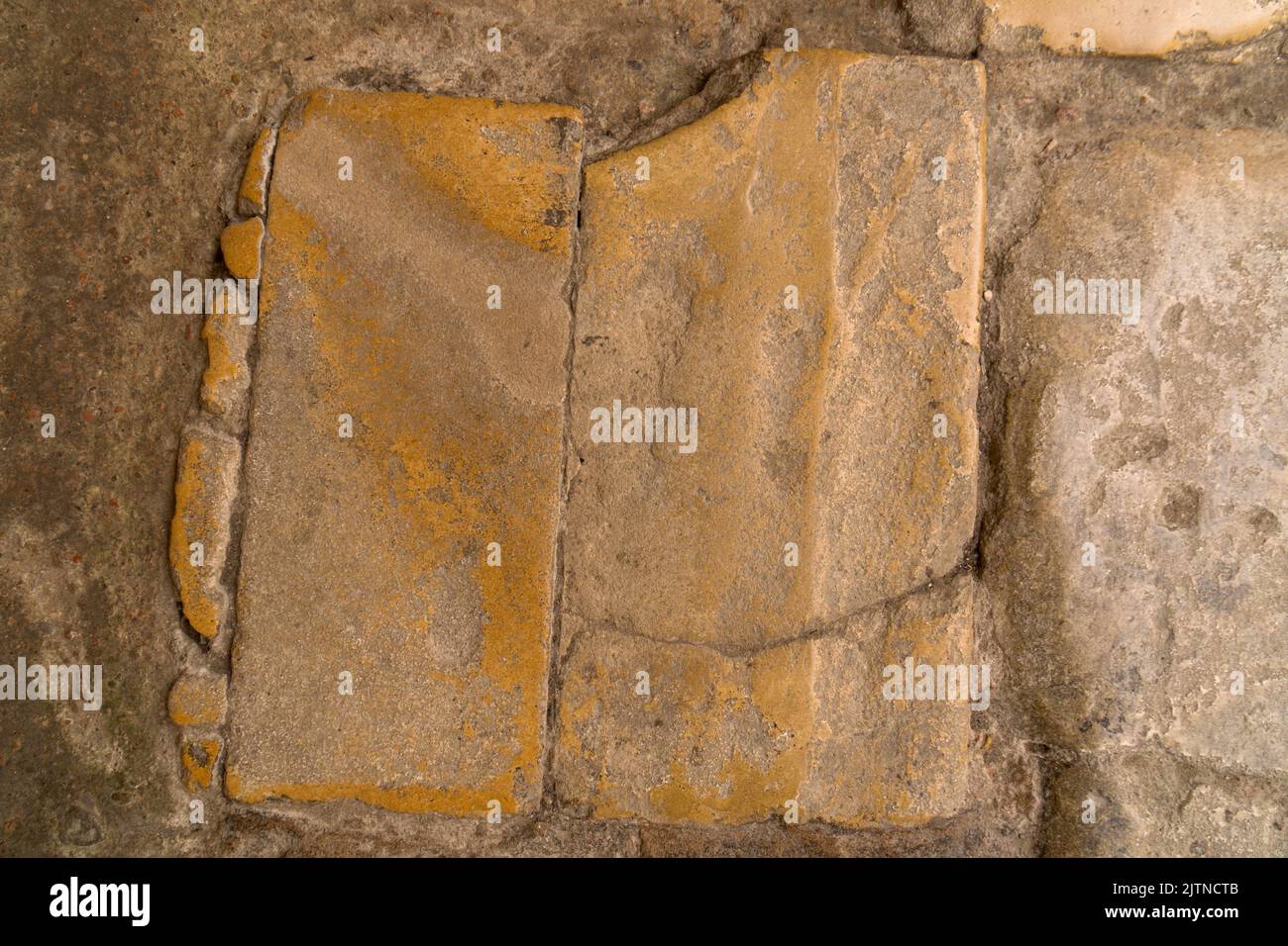 Worn smooth colored natural stone slab in an antique old heavily used ...