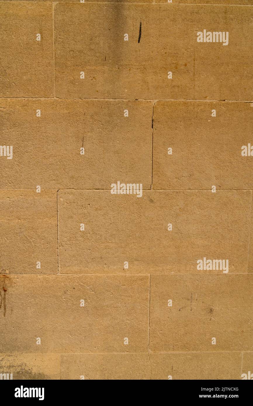 Historical beige yellow sandstone block brick wall close up old facade ...