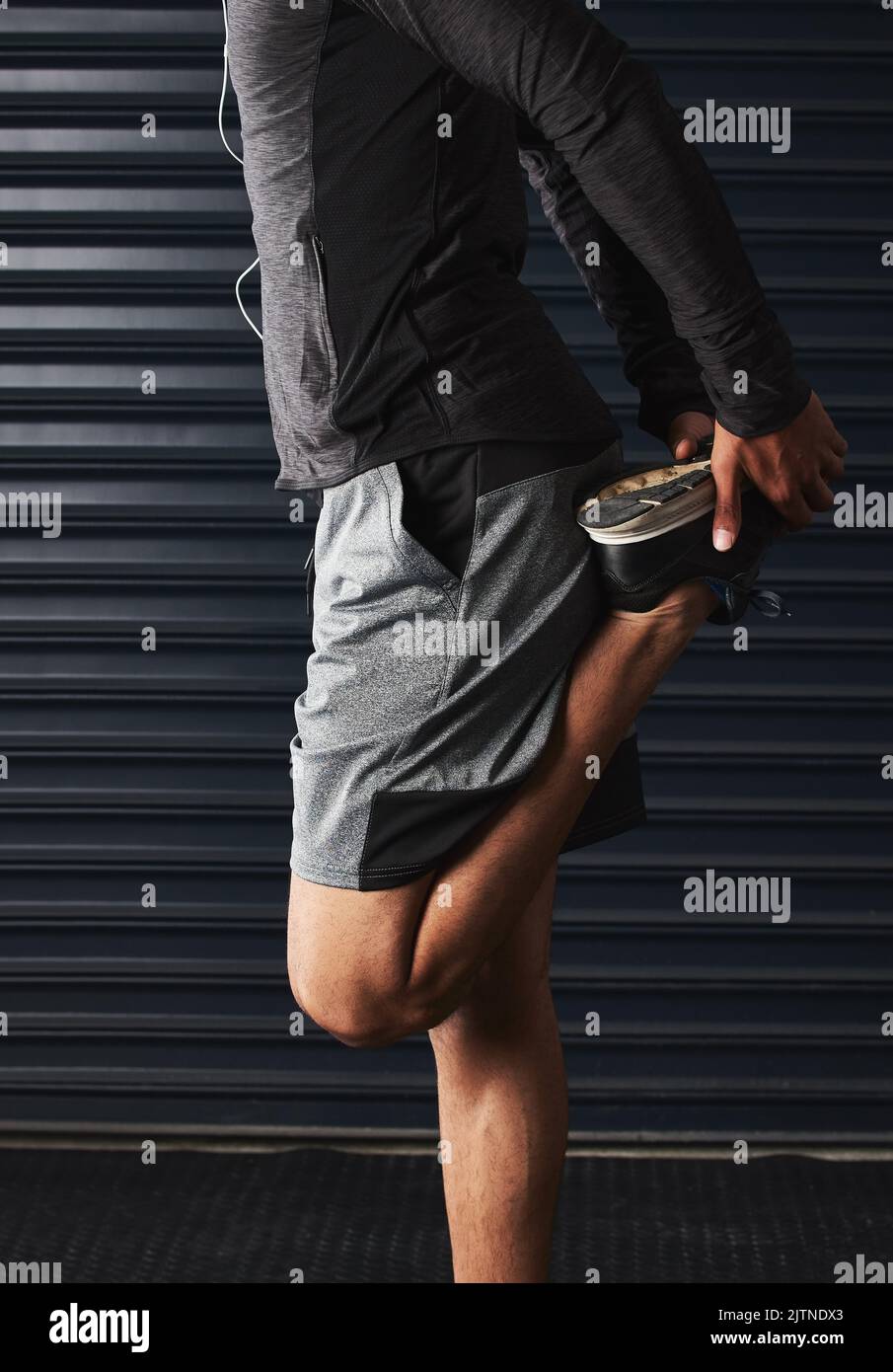 Work, sweat, achieve. an unidentifiable young man warming up before his ...