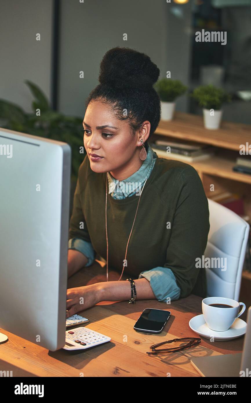 Working with purpose. an attractive young woman working on her computer ...