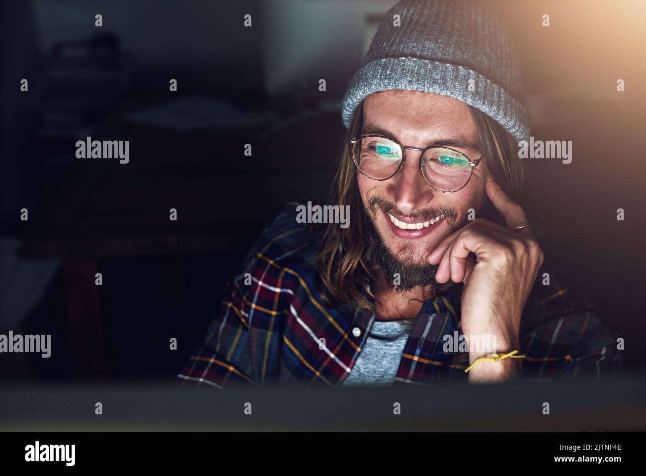 The ideas are flowing on the night shift. a designer working on his ...