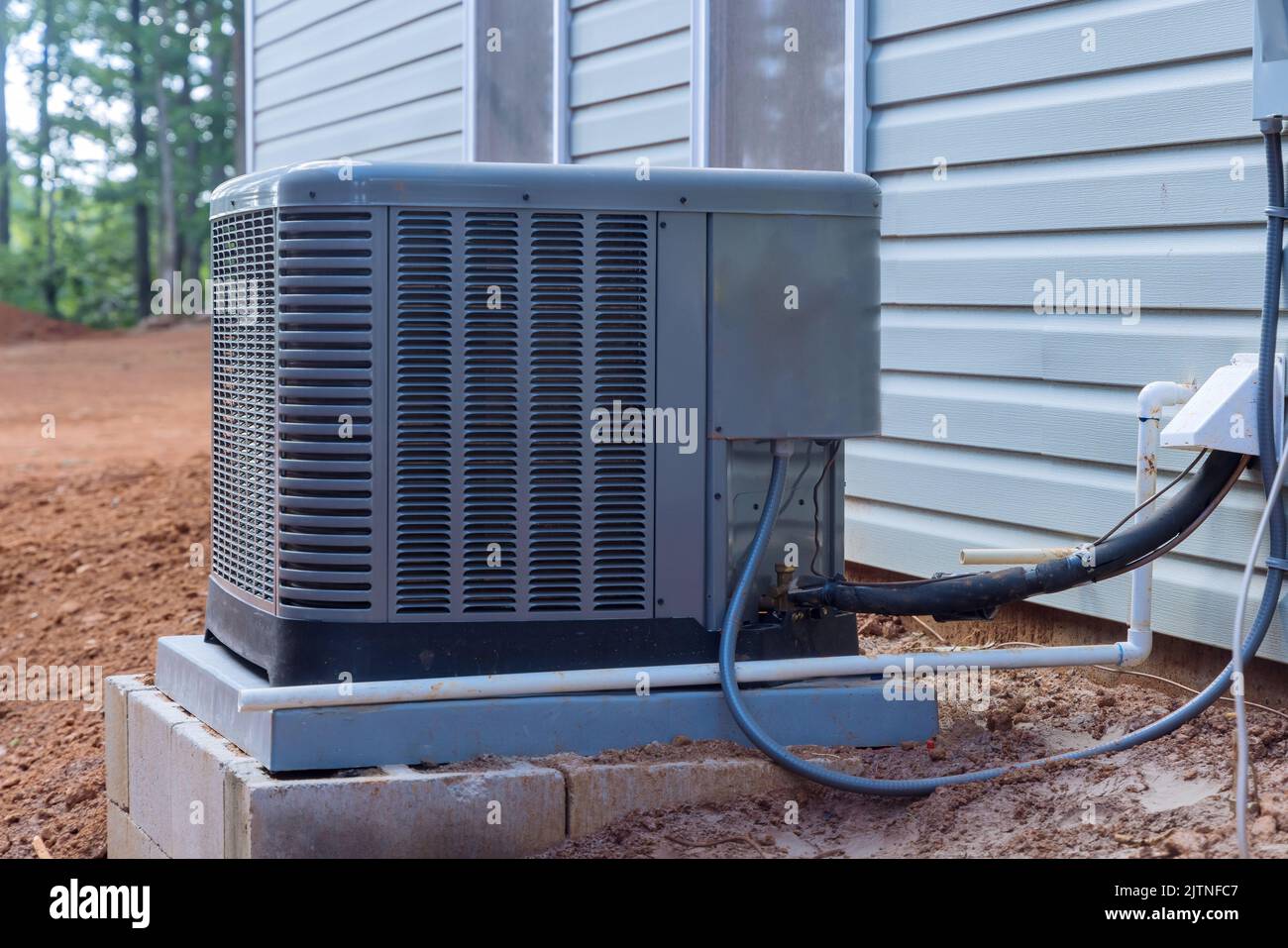 The installation of an electric air conditioner on the exterior of a ...