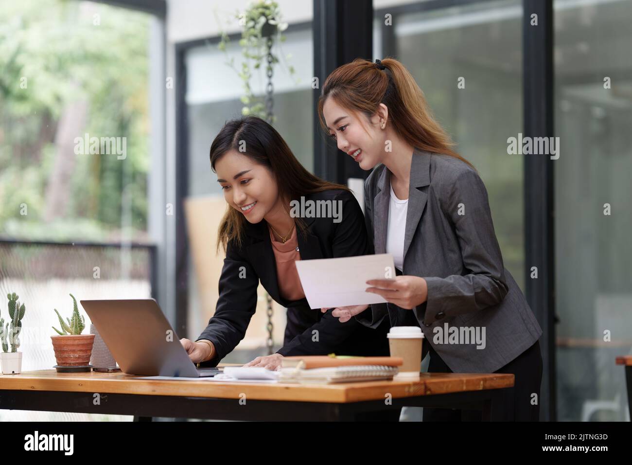 Two Asian Beautiful Business woman working and analysis financial ...