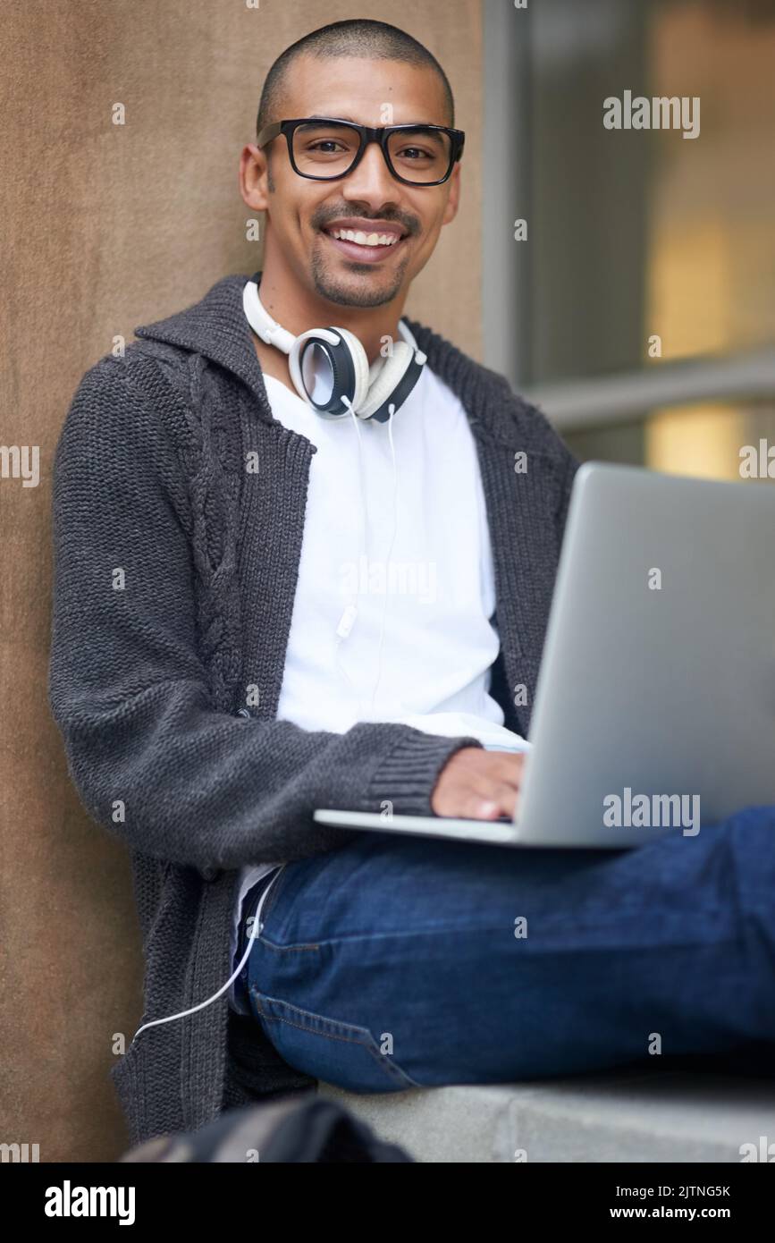 Study hard, but study smart. Portrait of a college student using his ...