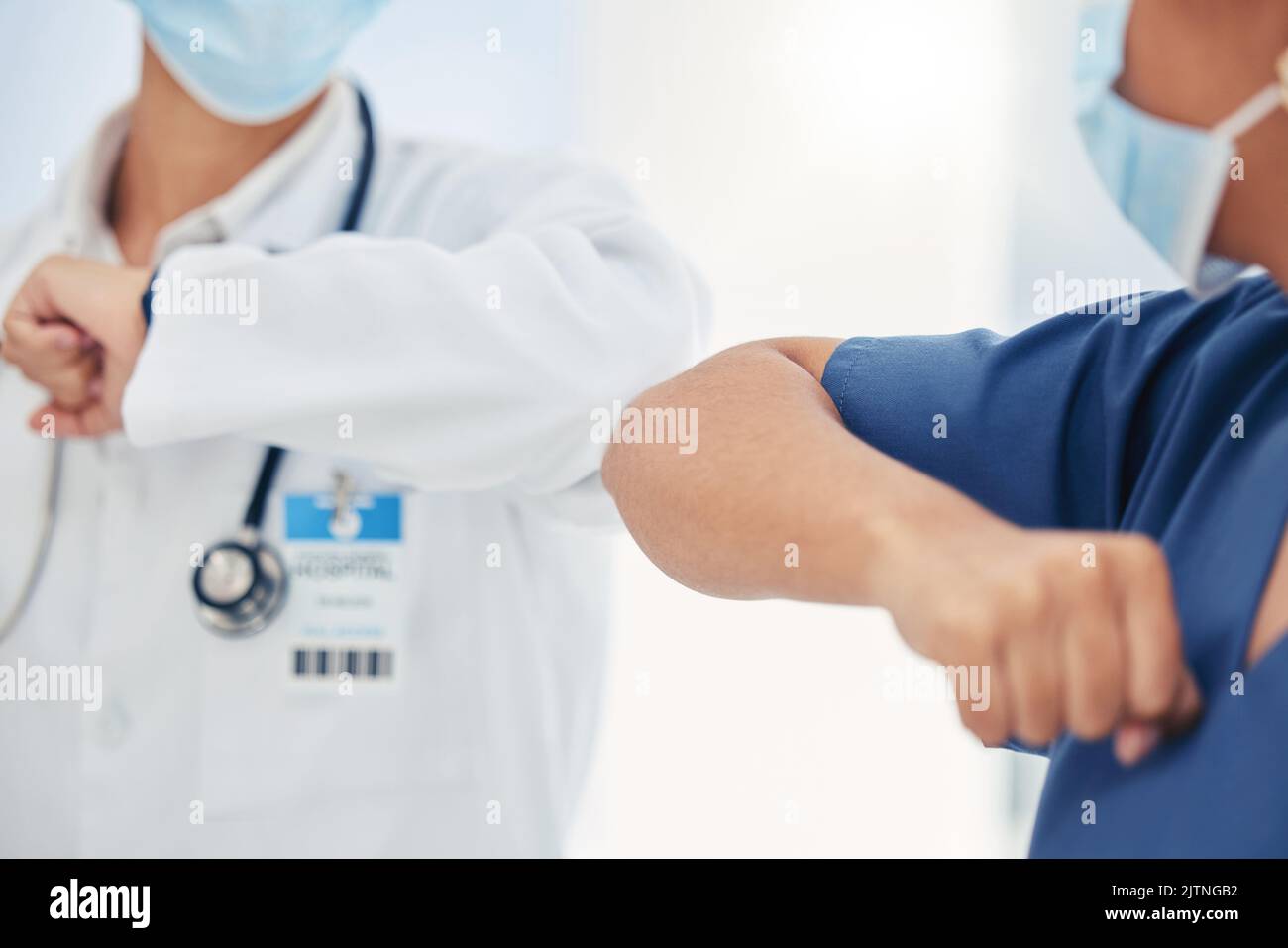 Covid handshake of a nurse and doctor as a surgery success, welcome or ...