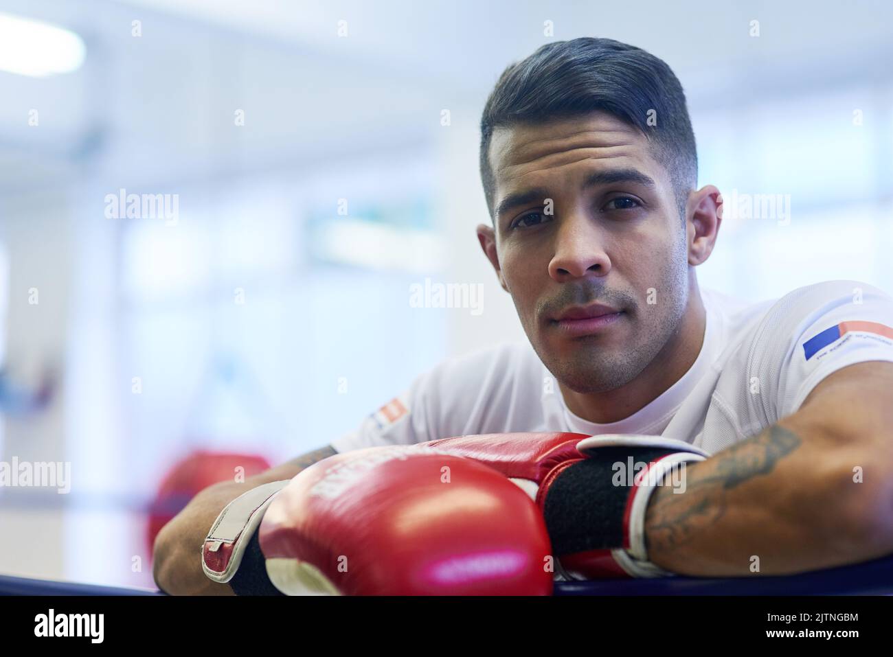 Step into my ring. Portrait of a young man leaning on the ropes while ...