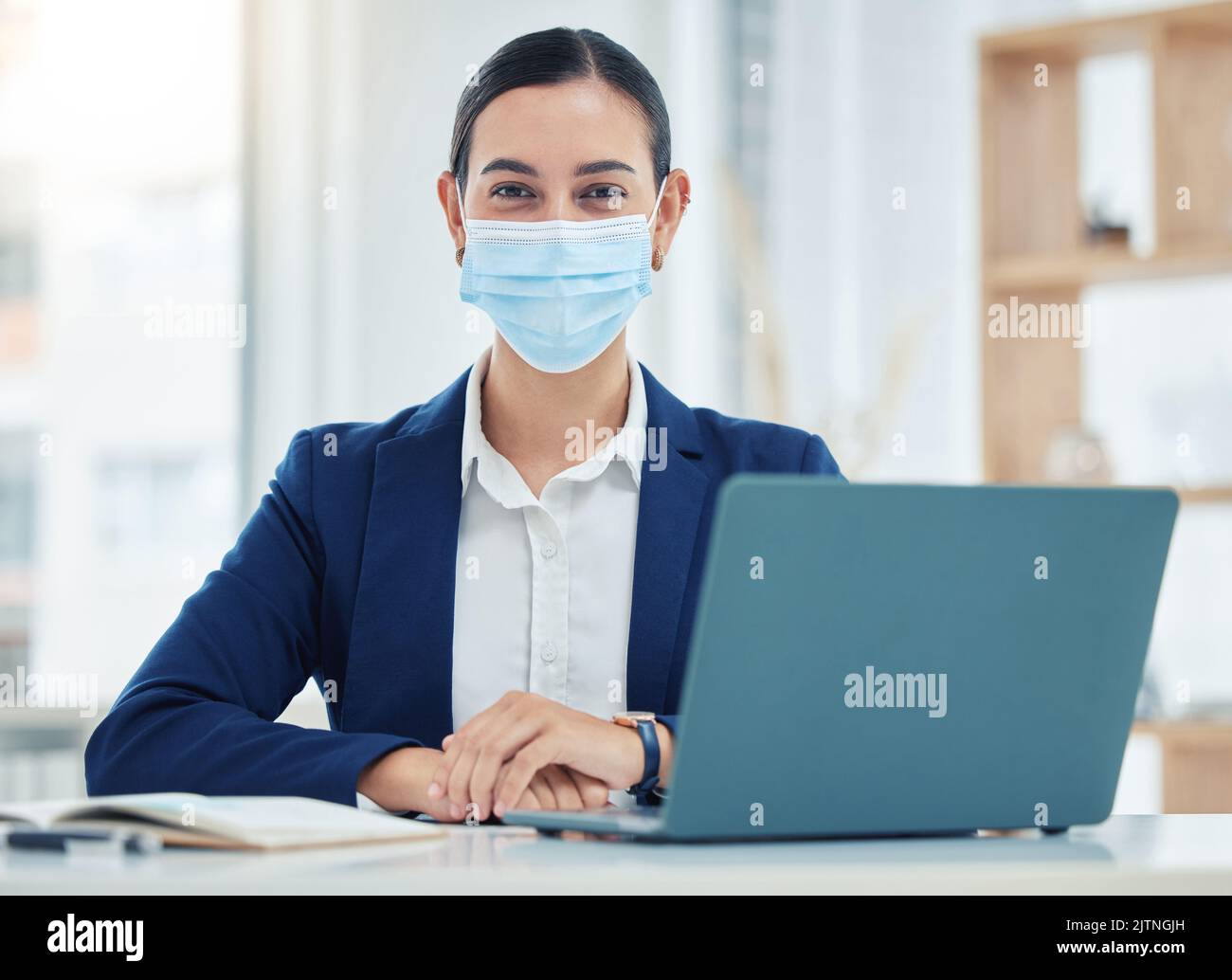 Compliance, face mask and covid rules at work with a business woman ...
