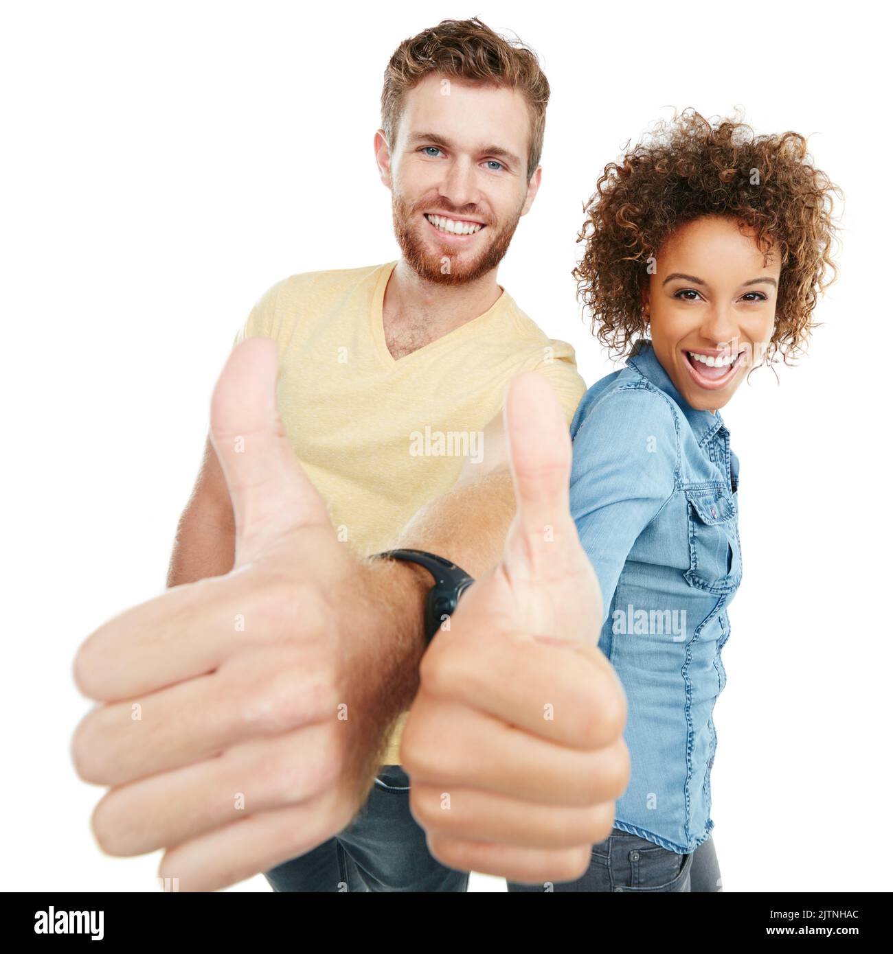 Thumbs up. Studio portrait of a young couple giving a thumbs up to the ...