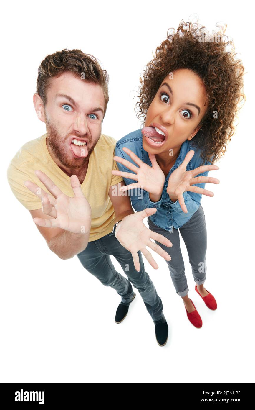 Getting a little crazy. Studio portrait of a young couple pulling faces ...
