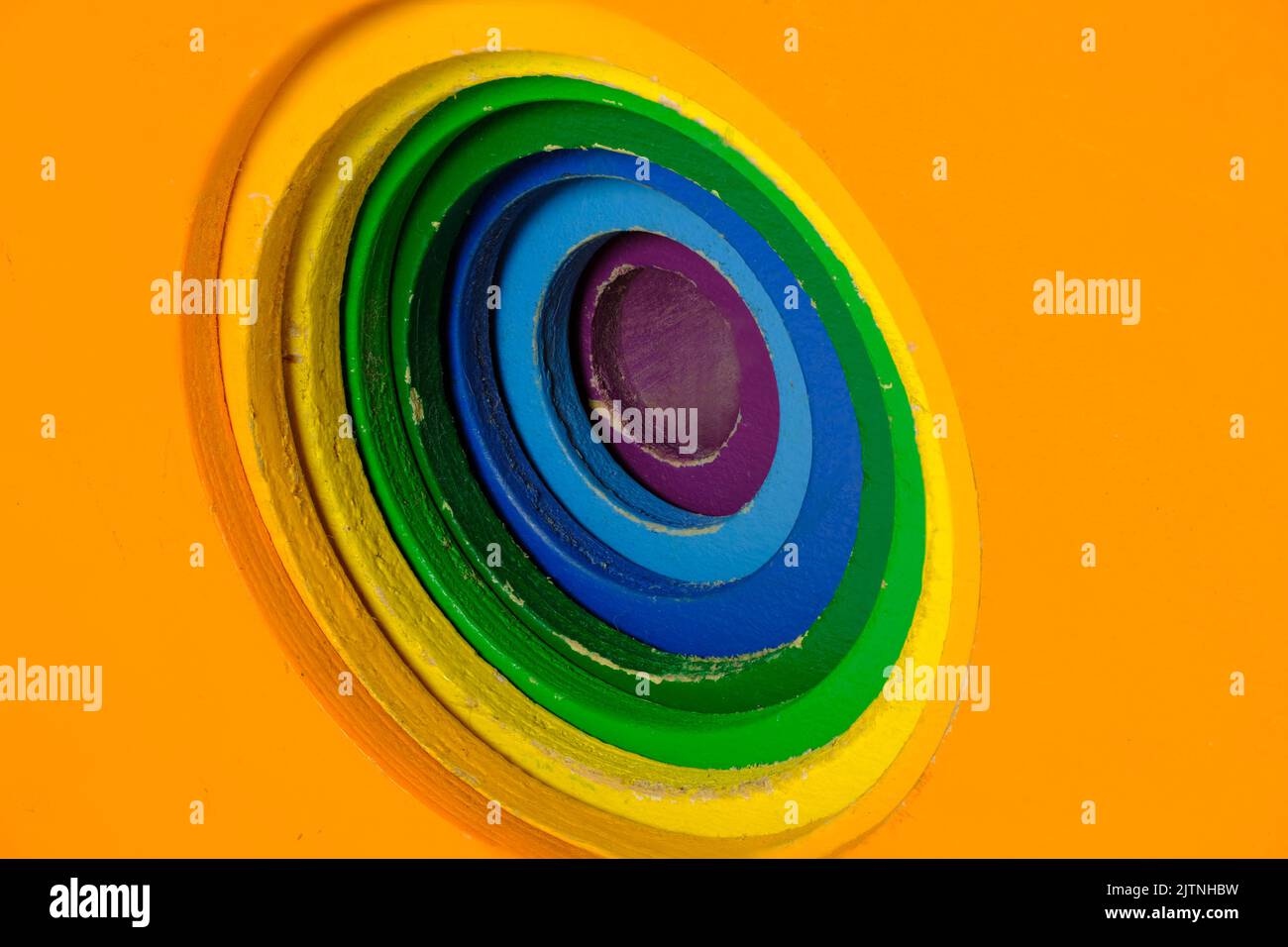 Multicolored children's wooden toy blocks with concentric circles cut into the side, stepped ...