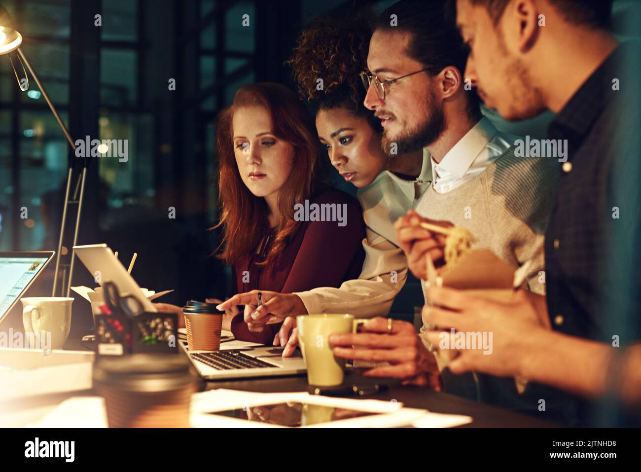 Working late to draft a blueprint on a project. a business team using a ...