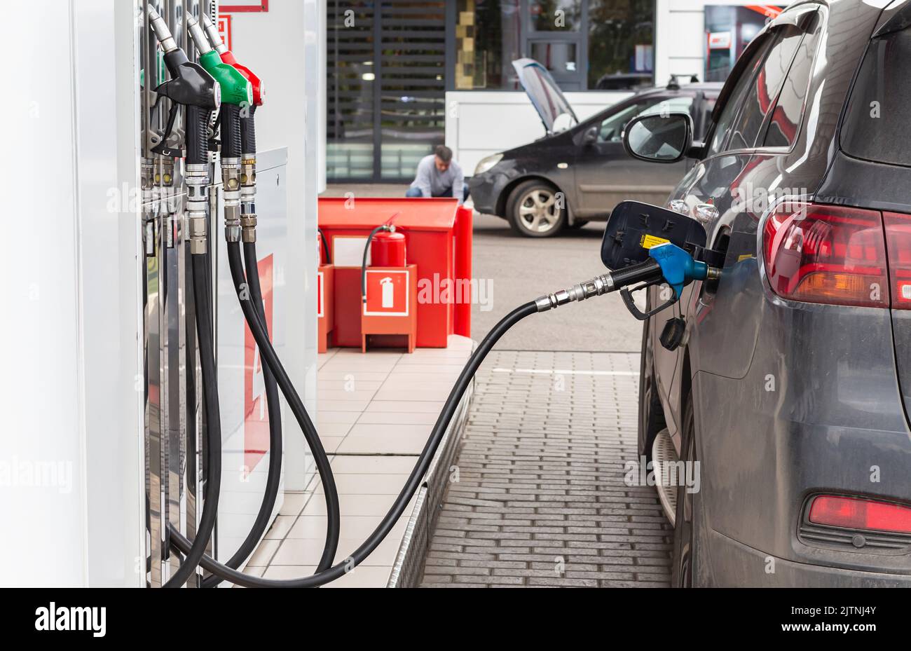 Refueling car with gasoline fuel at gas station. Fuel filling station ...