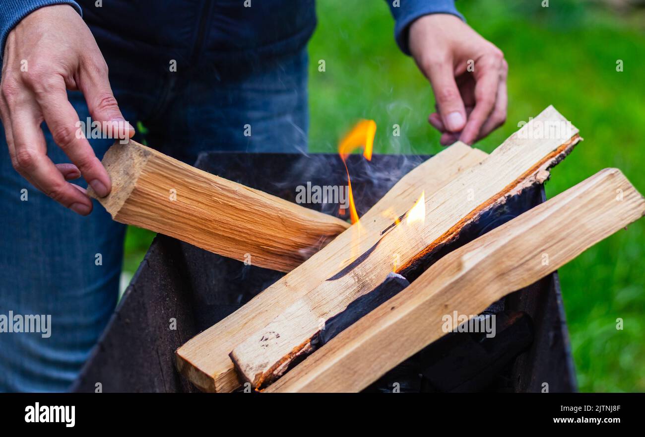 Man starting up wood stove hi-res stock photography and images - Alamy