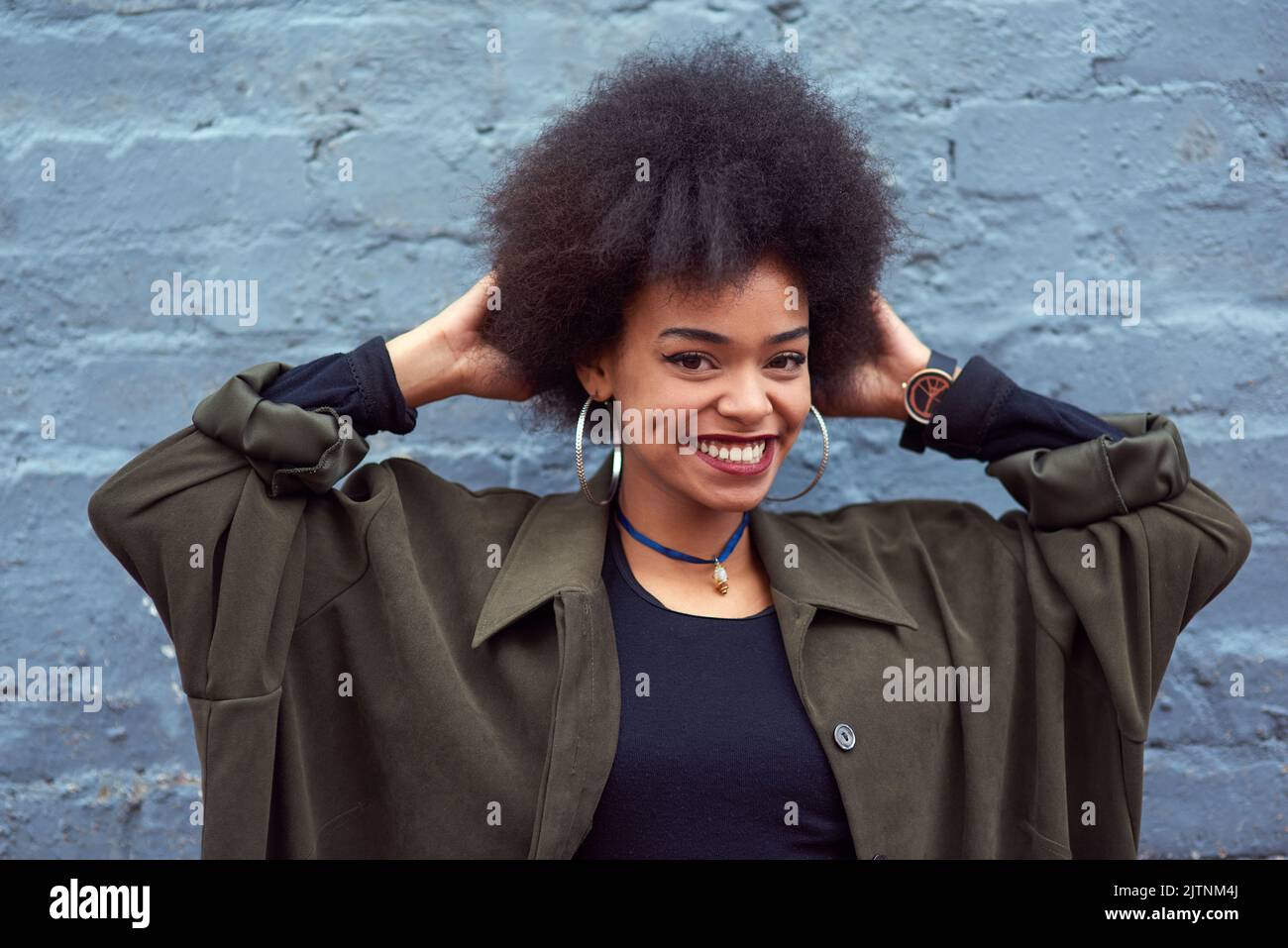 Calm, cool and confident. Portrait of a happy young woman standing ...