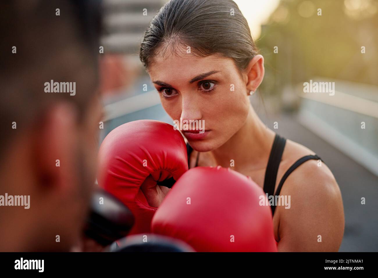 Focused on the fight. a young couple going through some kickboxing ...