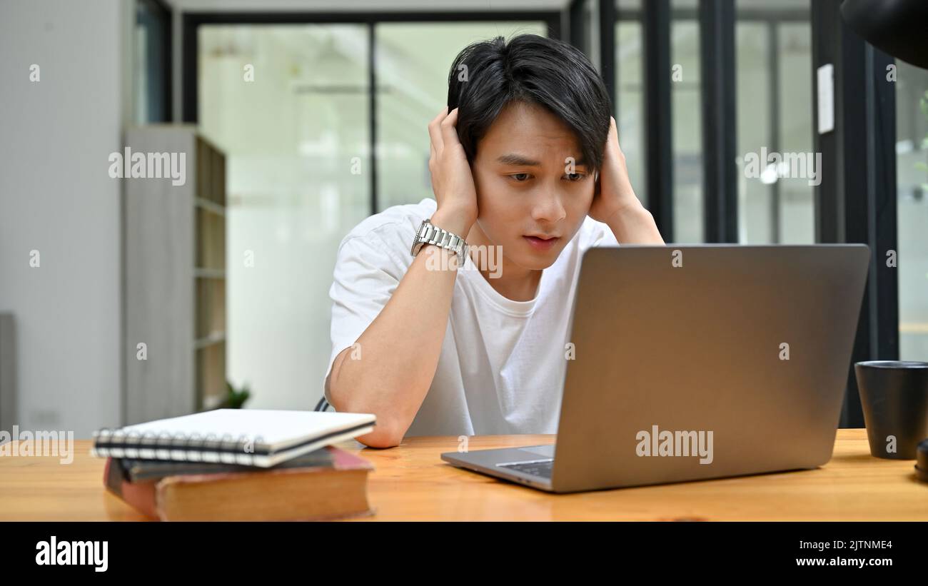 Stressed and depressed young Asian male office worker or college ...