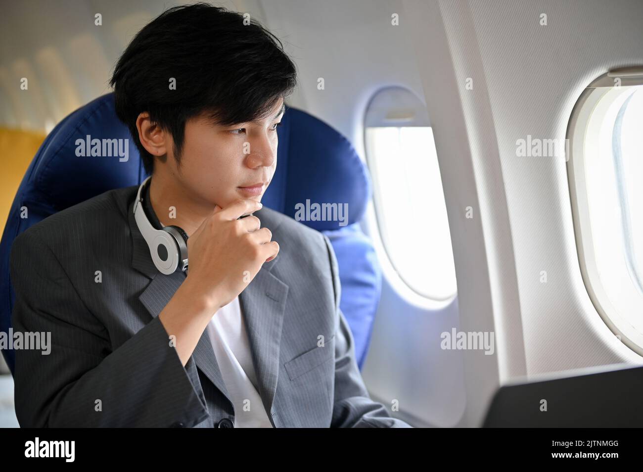 Smart and handsome young Asian businessman in formal suit is on the ...