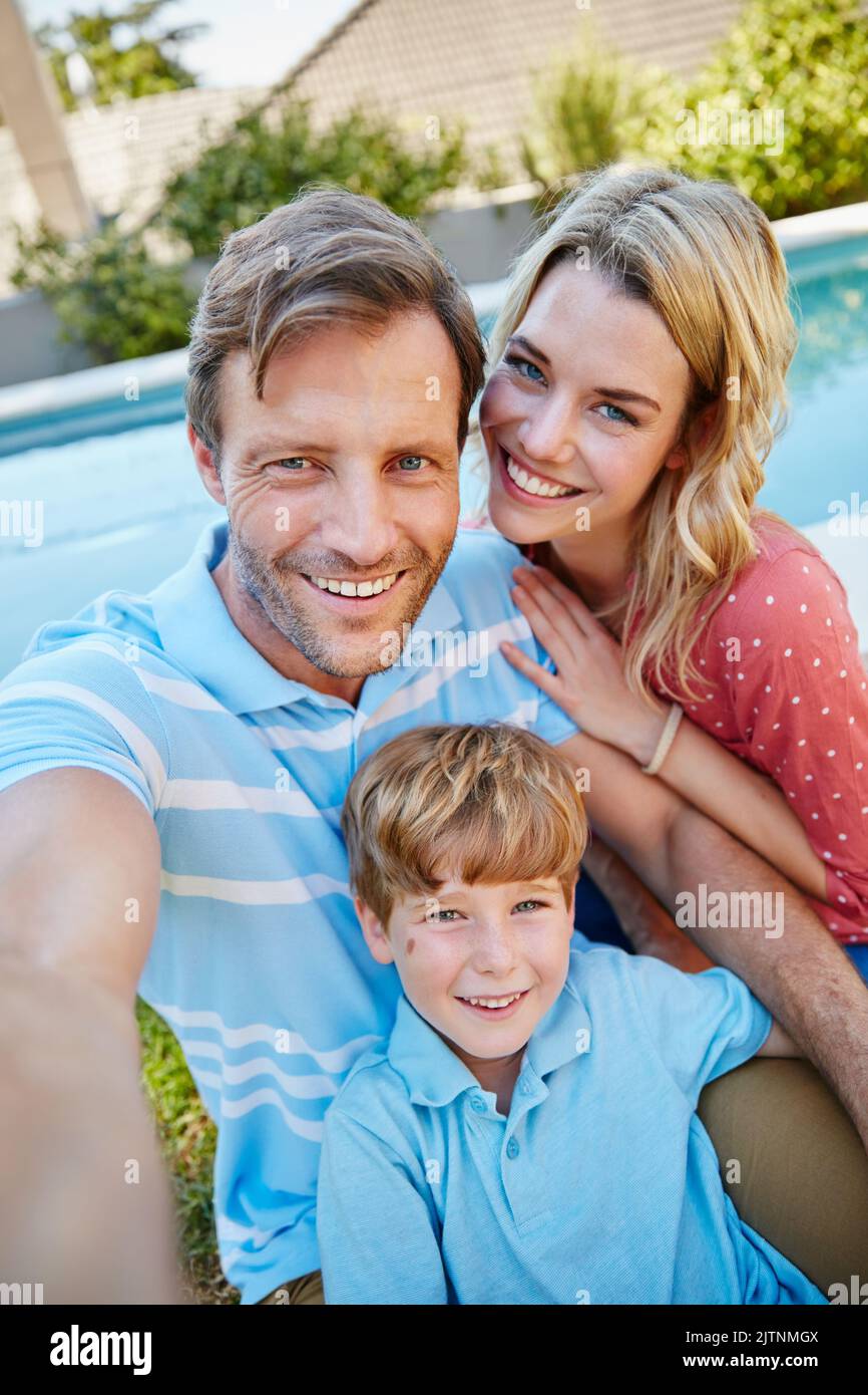 Making memories last forever. Portrait of a happy family taking a self-portrait together outside ...