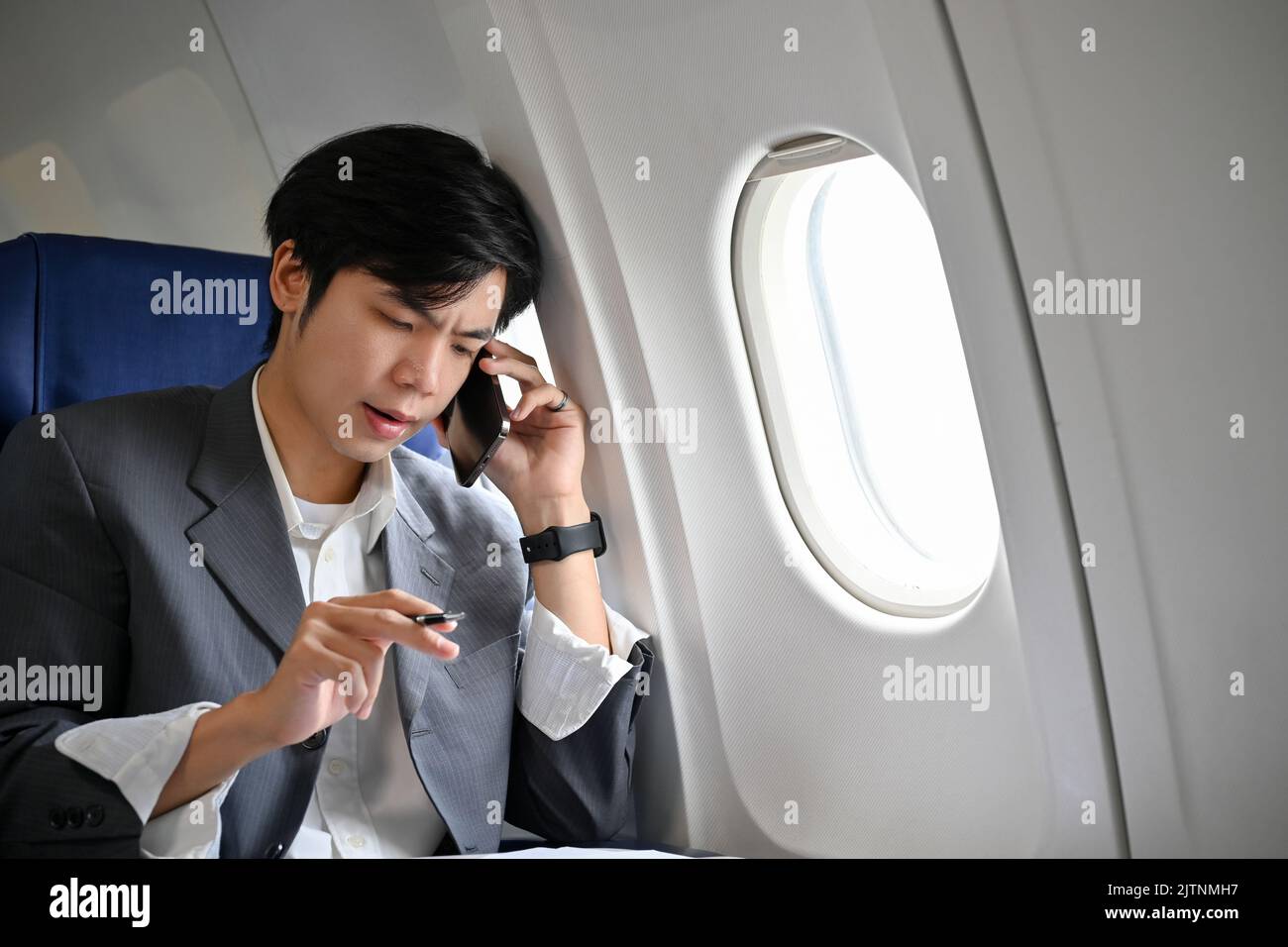 Serious man calling someone with his mobile phone Stock Photo - Alamy