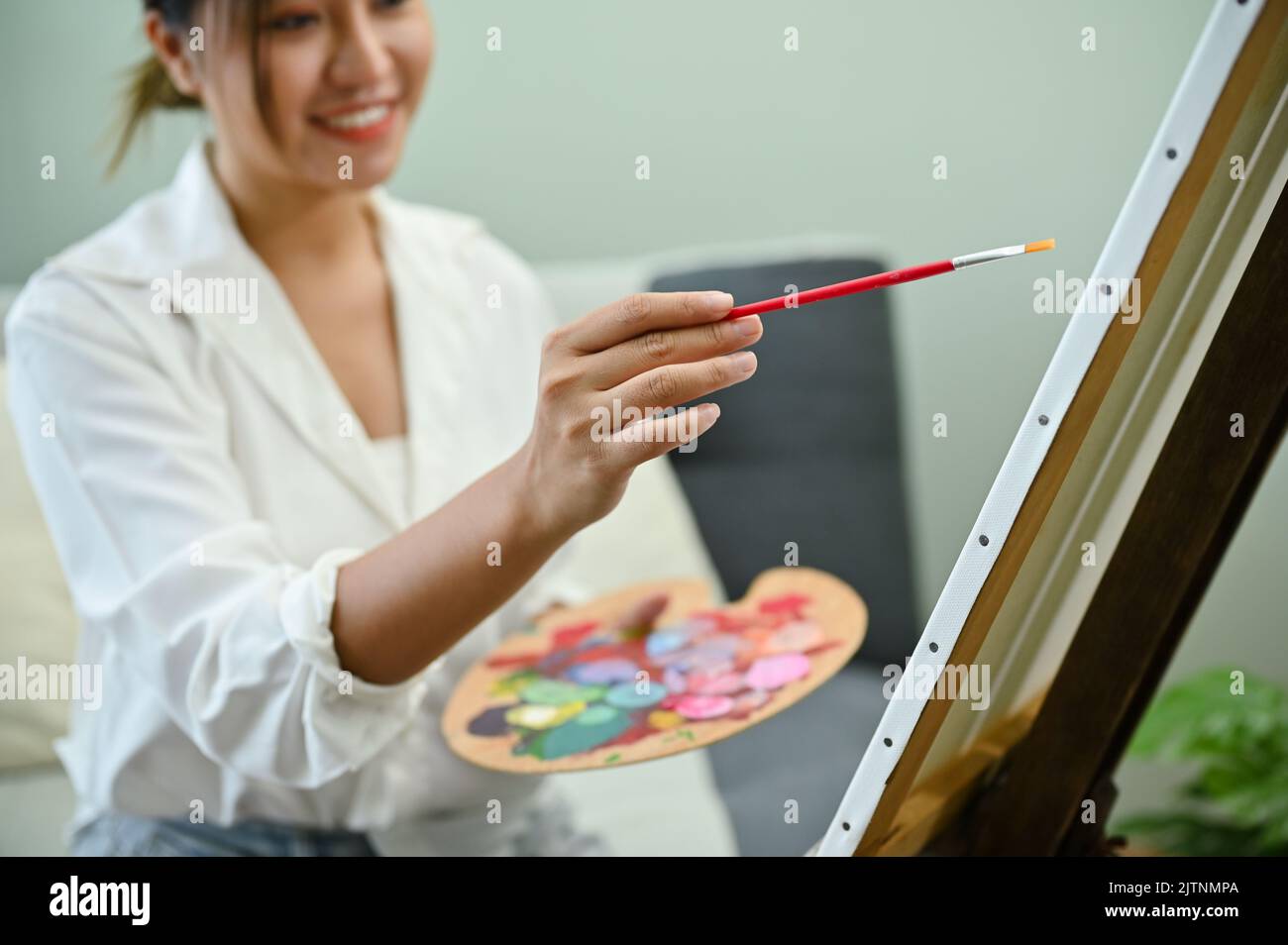 close-up image, Beautiful talented Asian female artist coloring her ...