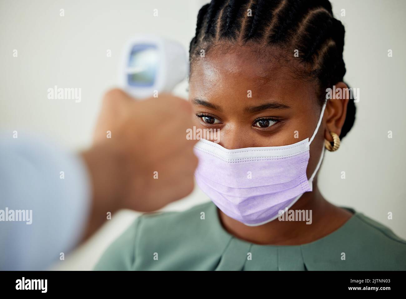 Covid, mask or doctor with an infrared thermometer to take temperature ...