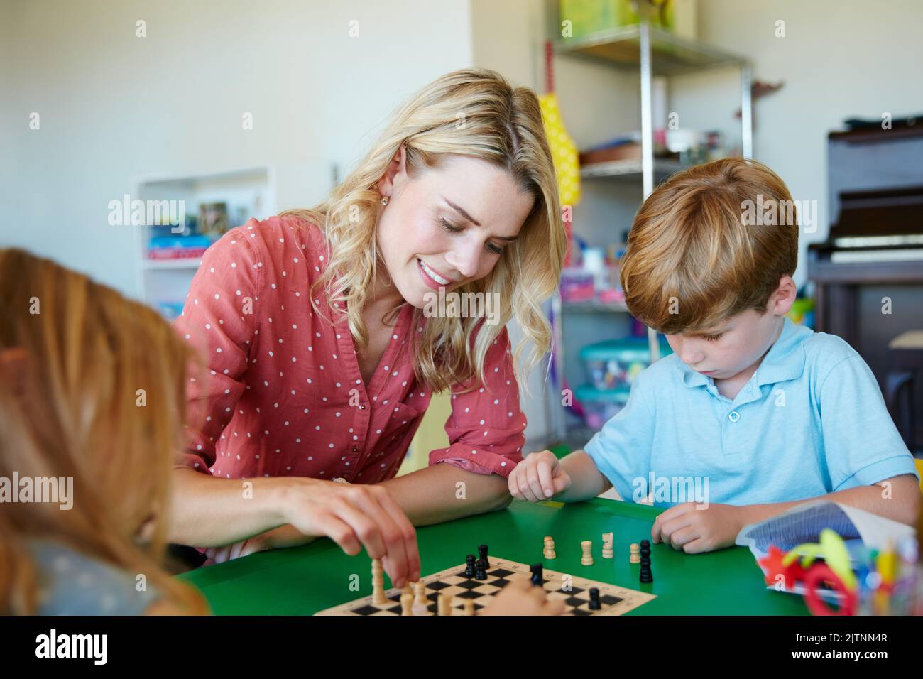 Checkmate. a mother having fun with her two kids at home Stock Photo ...