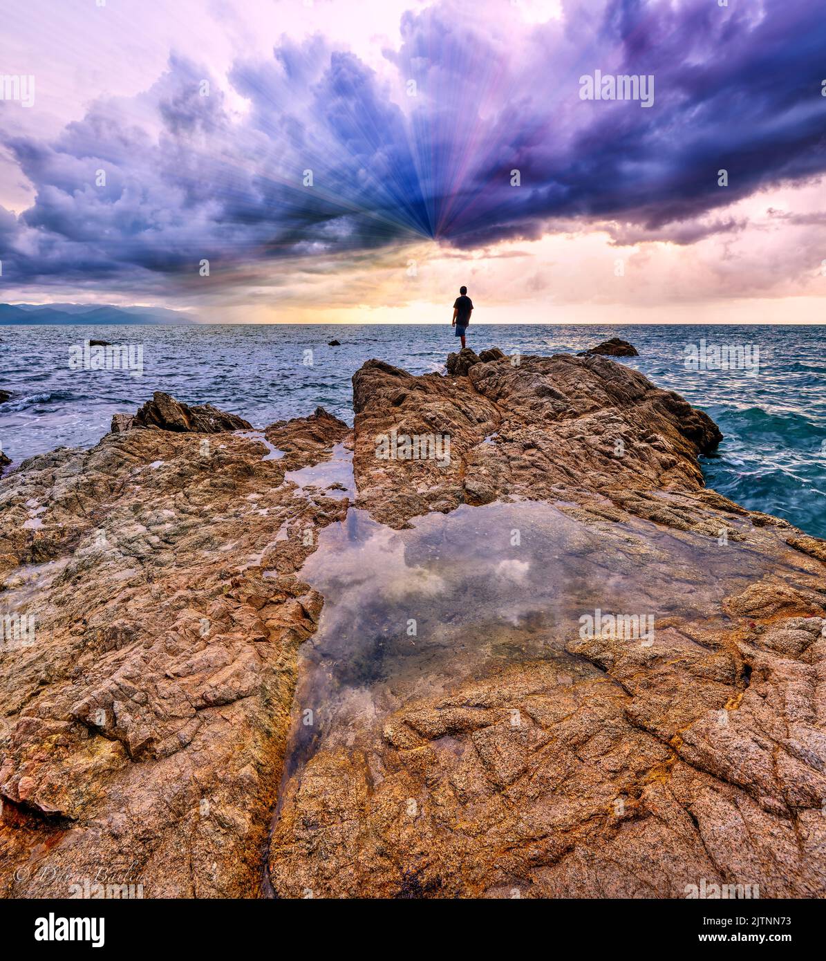 A Man Is Looking In Awe At Colored Light Beams Emanating From The Sky ...