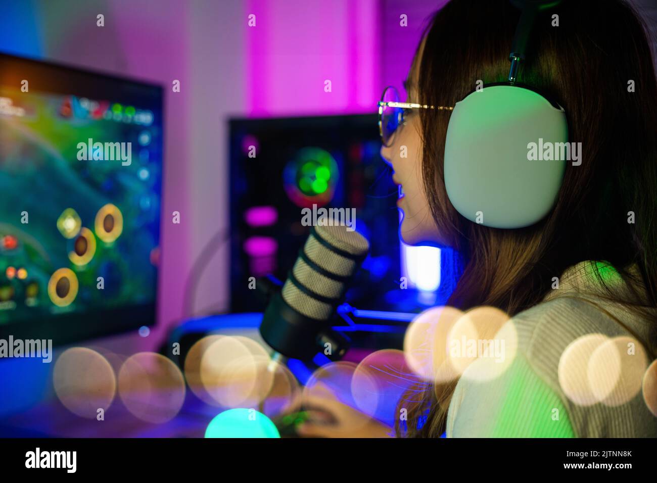 Asian young gamer woman playing video games online on computer she live ...